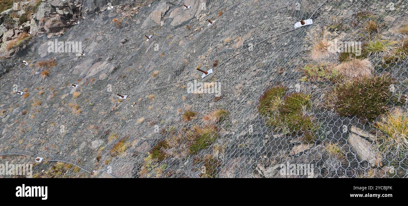 a steel net as security against falling rocks Stock Photo - Alamy