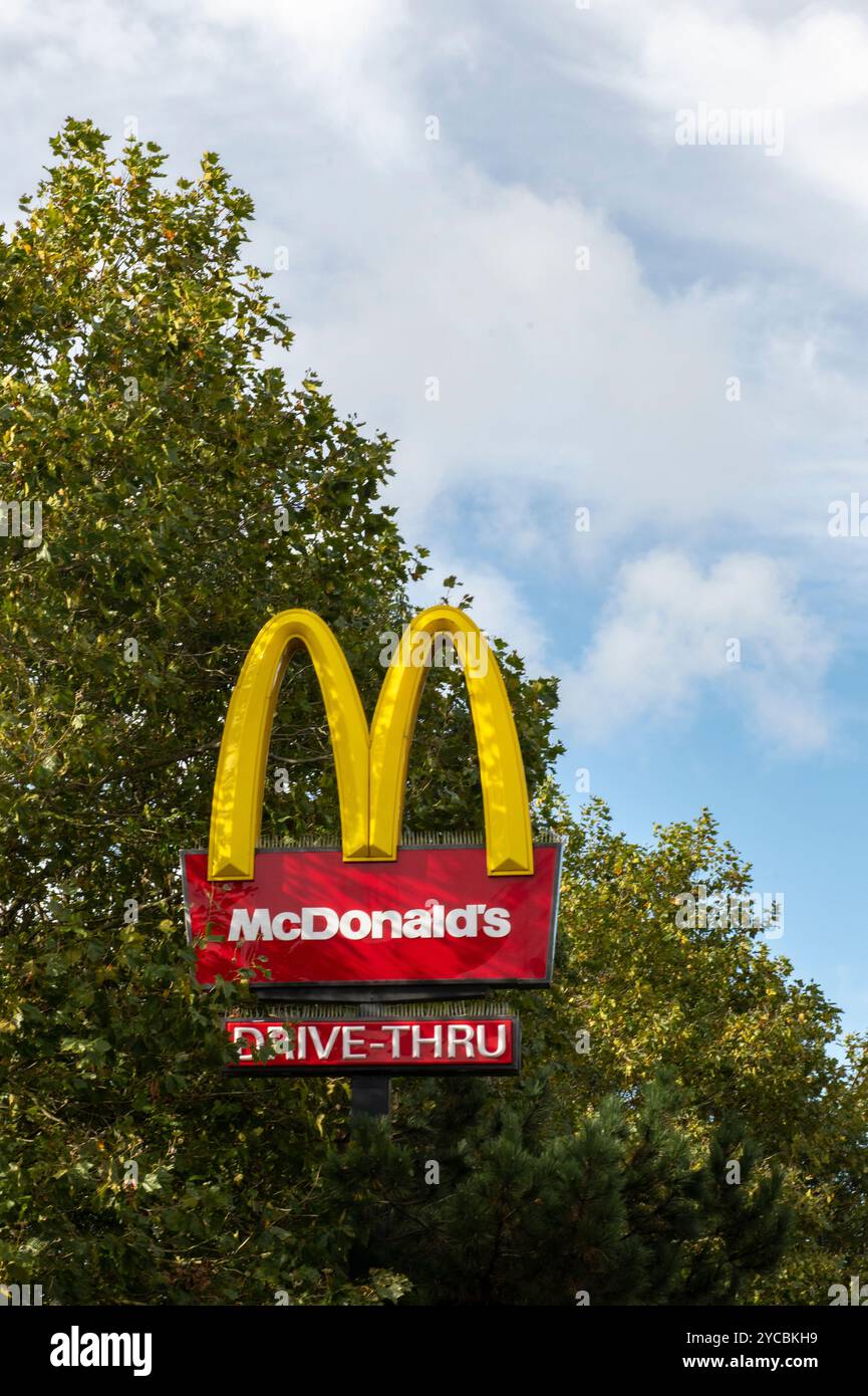 large MacDonalds burger restaurant fast food outlet sign with trees and ...