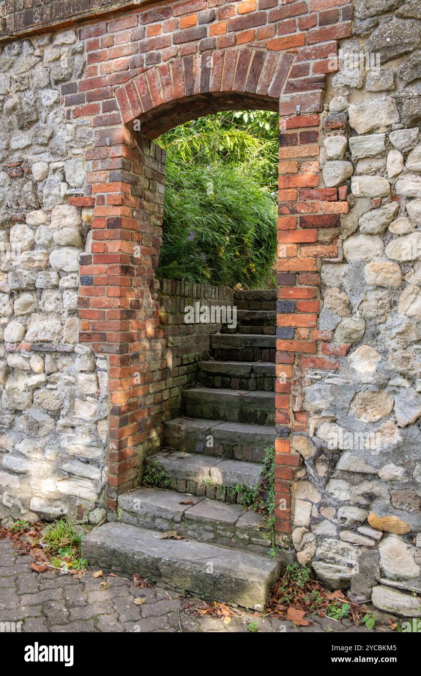 red brick archway built into an historic stone wall in the old city ...