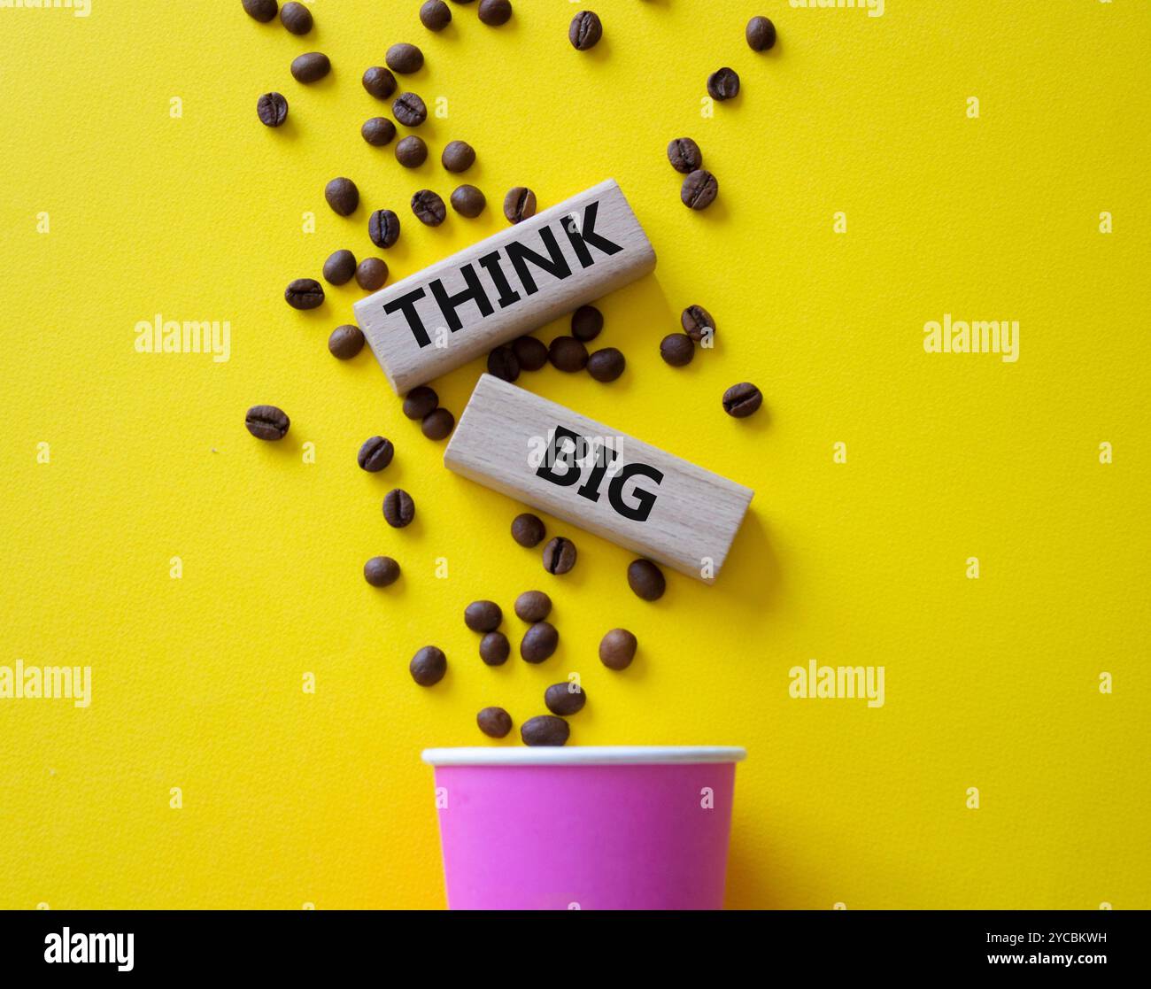 Think big symbol. Wooden blocks with words Think big. Beautiful yellow ...