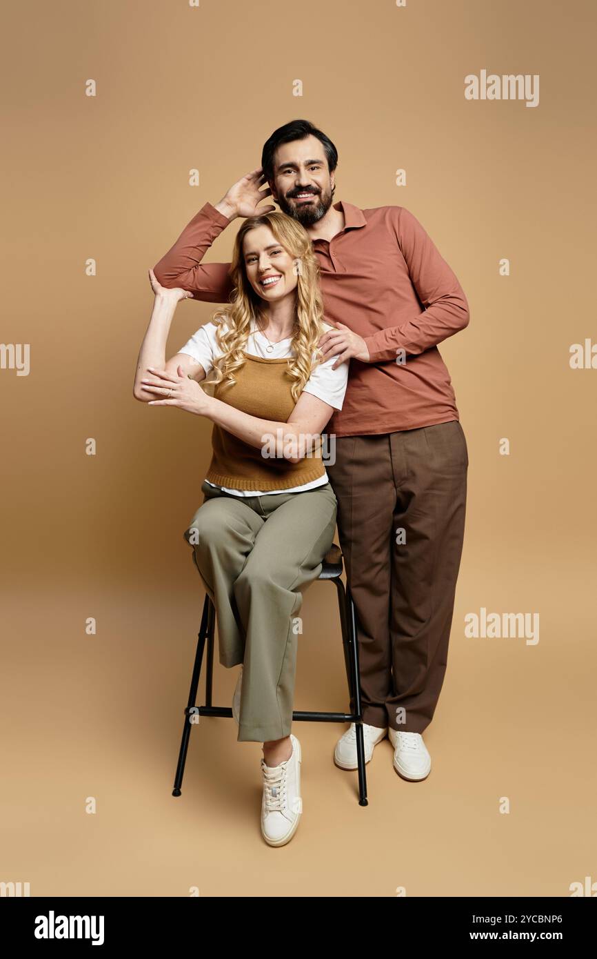 A cheerful couple enjoys a fun pose, showcasing their connection and ...