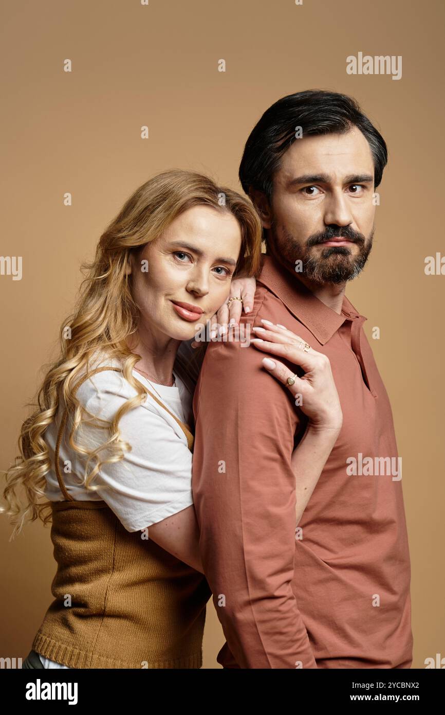 A couple shares a playful moment, embracing warmly in a cozy, inviting ...