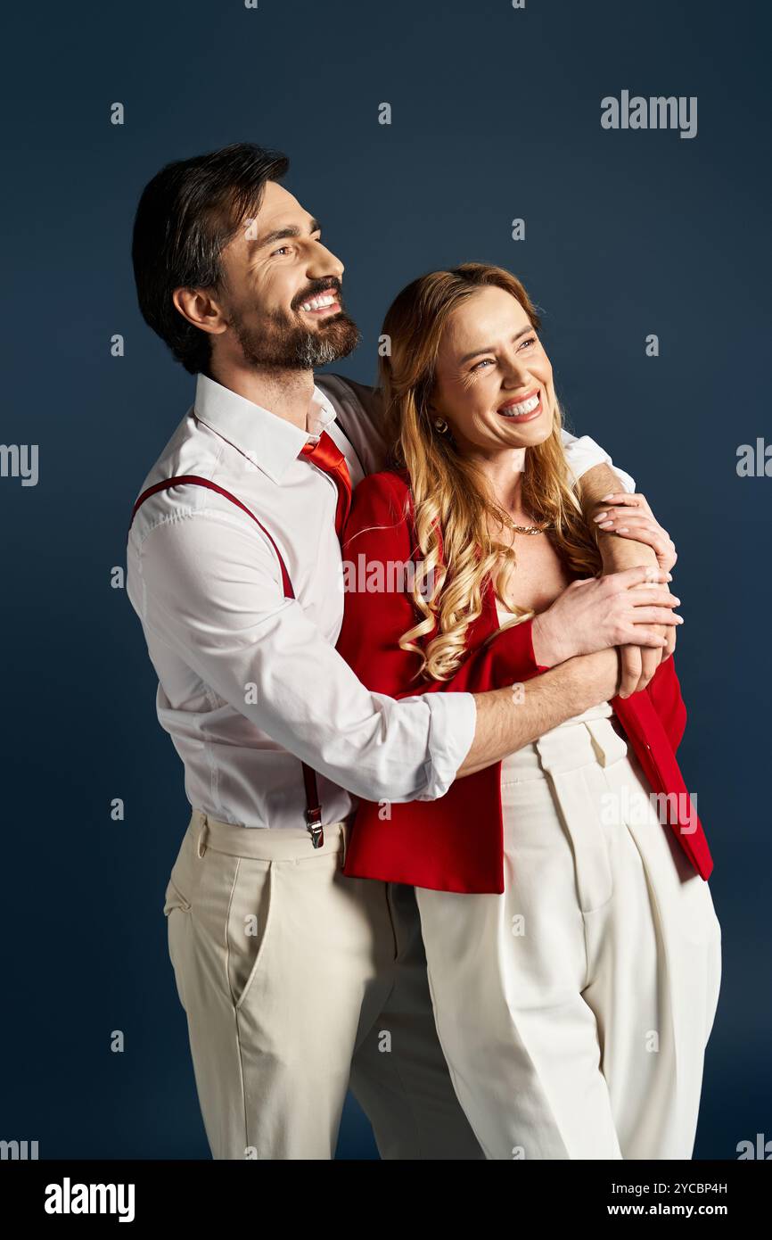 A middle aged couple shares a warm laugh while embracing in a chic ...