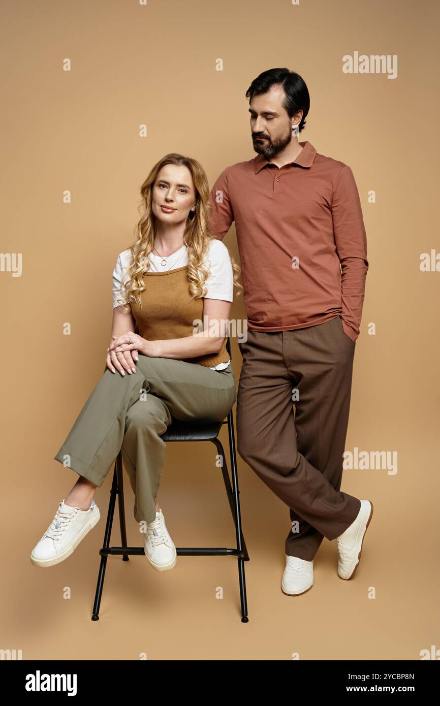 A middle aged couple stands confidently with a soft focus on their ...