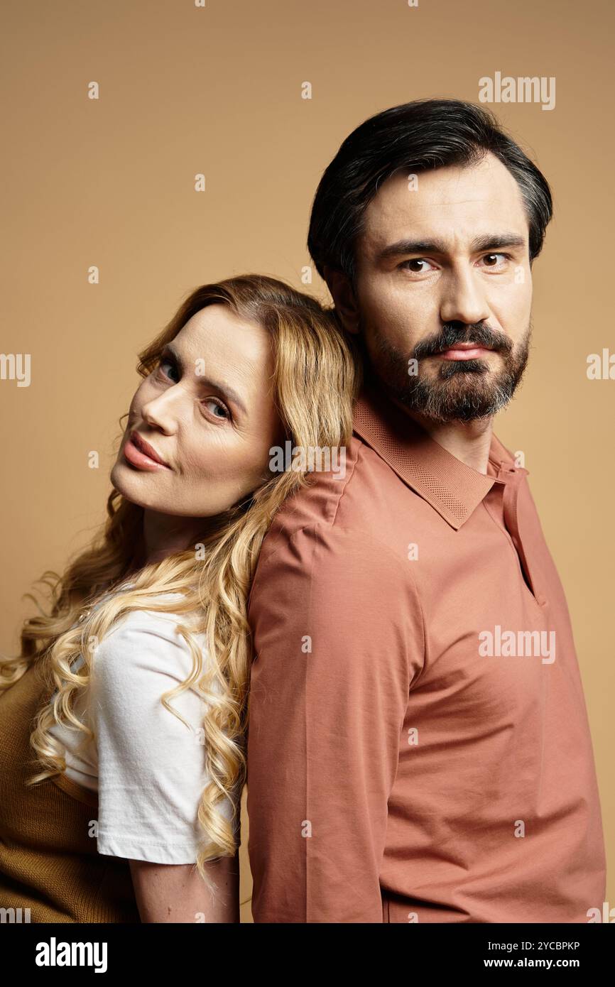 Two middle aged people share a warm, intimate moment against a soft backdrop Stock Photo - Alamy