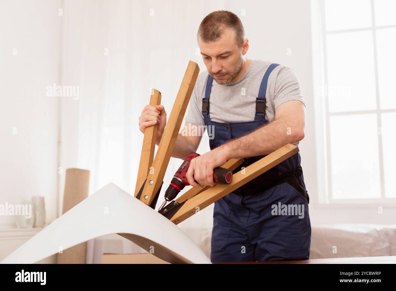 Professional Craftsman Carpenter Installing Table Using Electric Drill ...