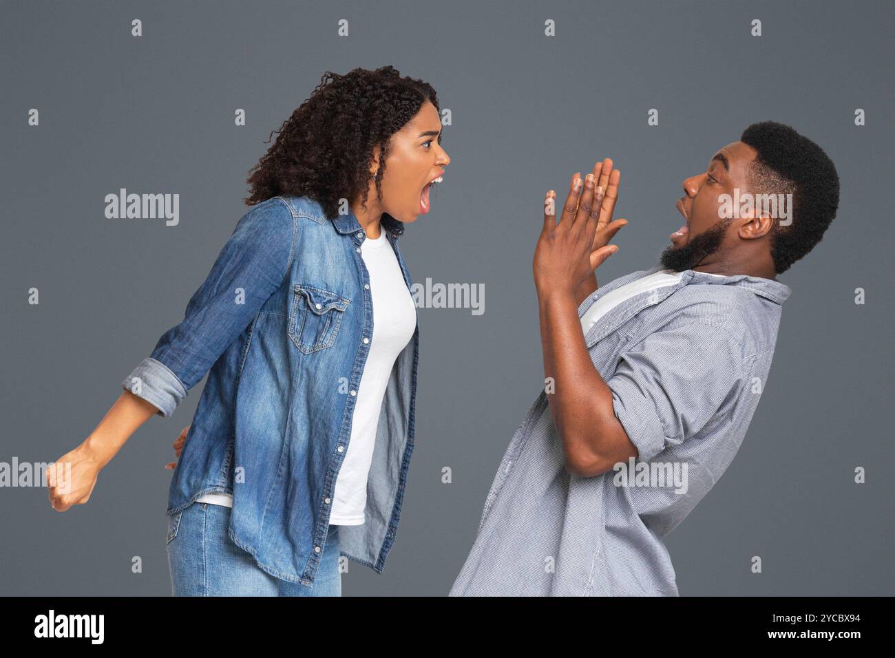 PMS Concept. Mad african american woman yelling at her scared boyfriend ...