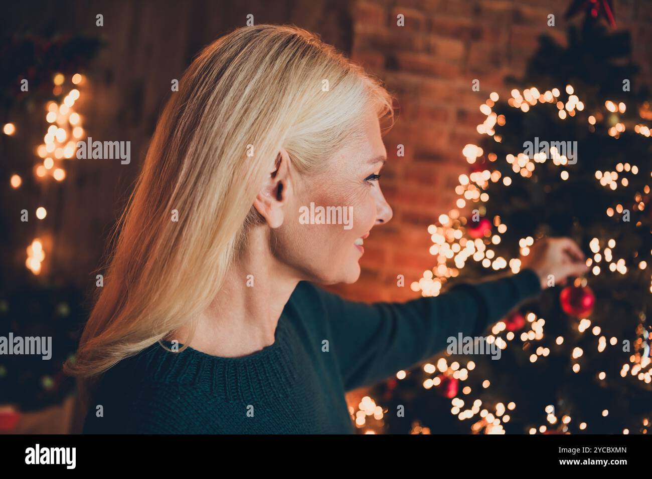 Photo of pretty retired woman adorn decorate tree dressed christmas ...