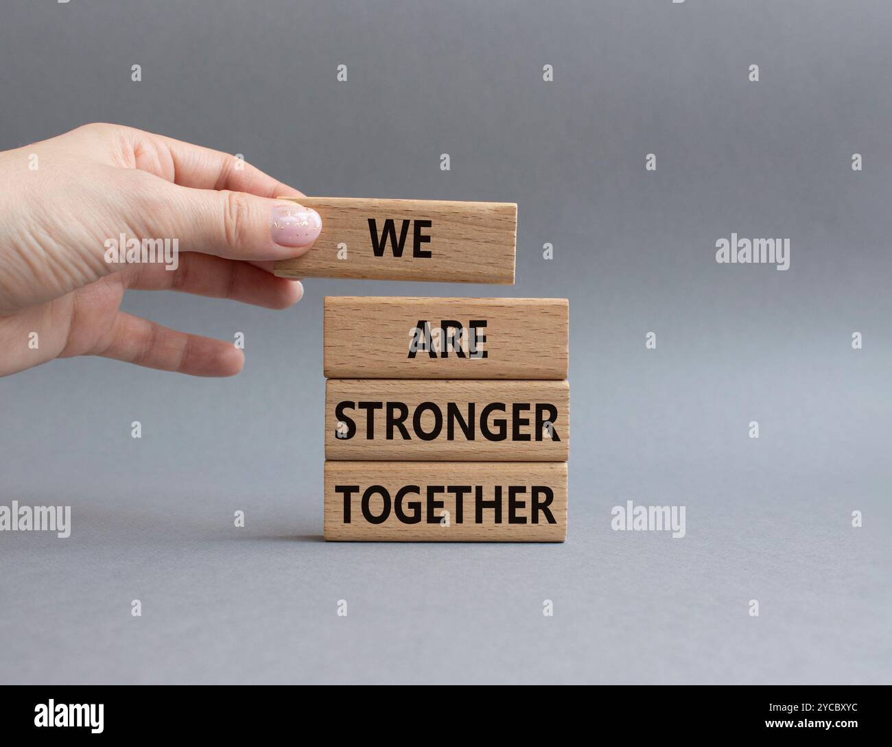 We are stronger together symbol. Wooden blocks with words We are ...
