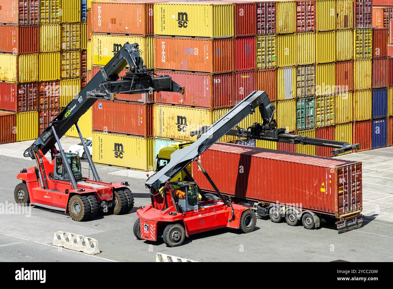La Spezia, Italy - May 28, 2024: Forklifts are loading cargo containers ...