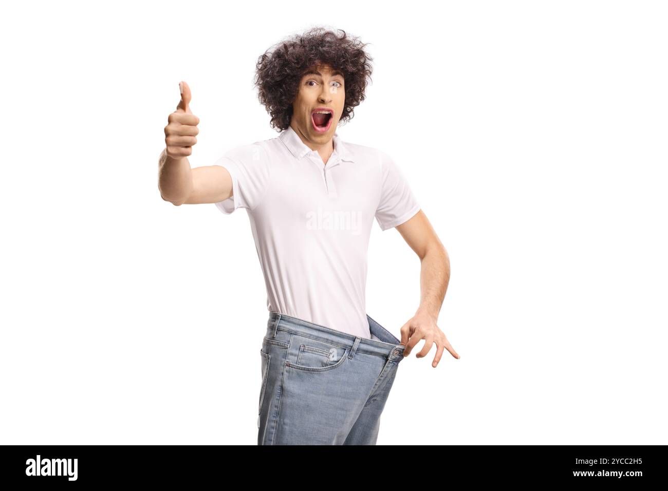 Excited guy trying on jeans and gesturing thumbs up, weight loss ...