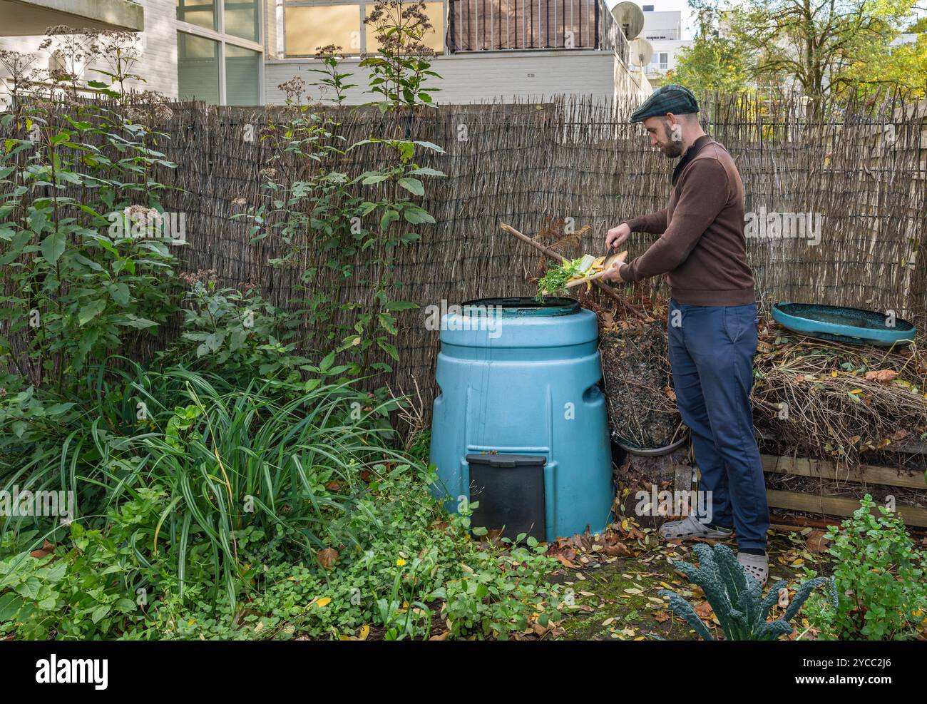 Man Disposing of Biodegradable Kitchen Waste into a Large Garden ...