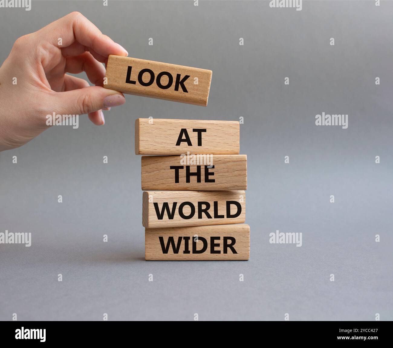 Look at the world wider symbol. Wooden blocks with words Look at the ...