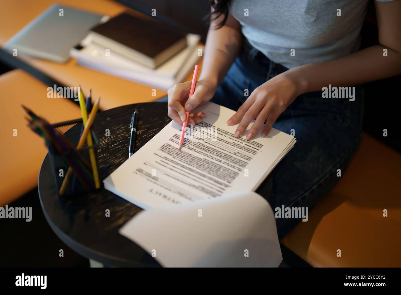 Asian teenage student woman using color pencil to highlight data in ...