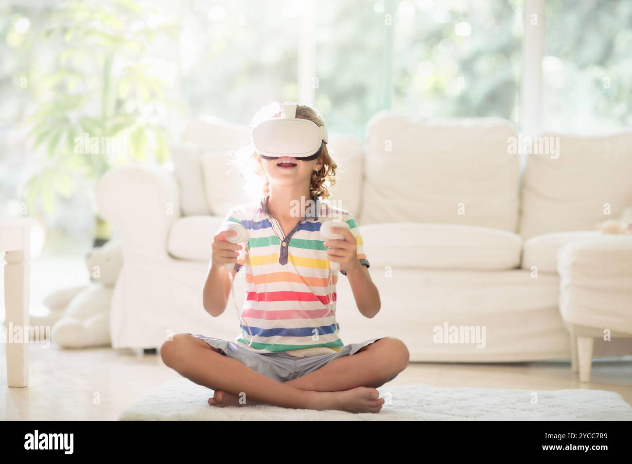 Child in virtual reality goggles. VR set for kids. Little boy playing ...