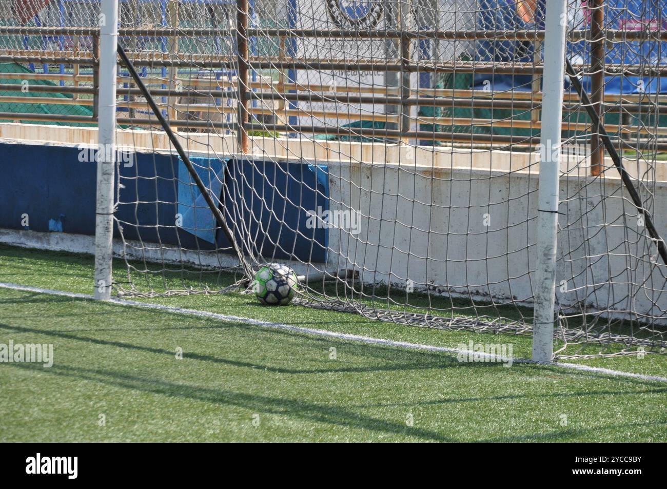 Soccer Ball in Goal Net on a Green Turf Field Stock Photo - Alamy