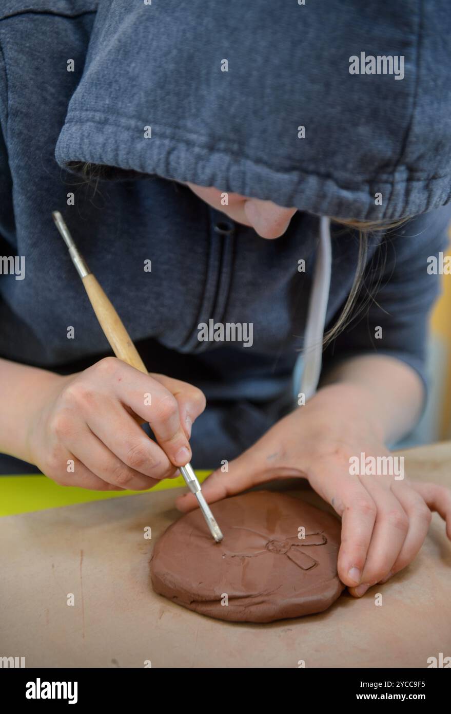 Schoolchild working clay in an art class Stock Photo - Alamy