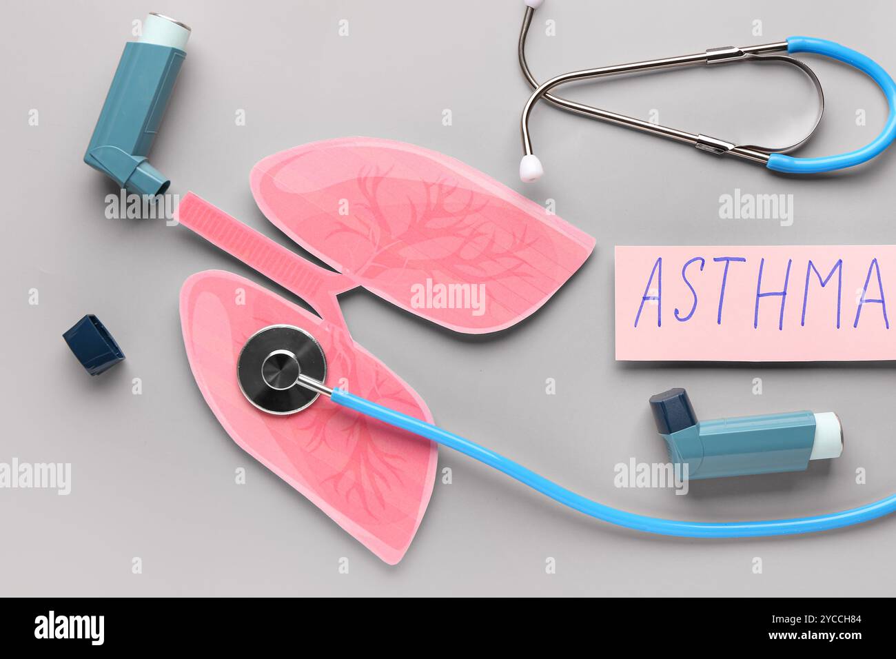 Inhalers, paper lungs, stethoscope and paper sheet with text ASTHMA on ...