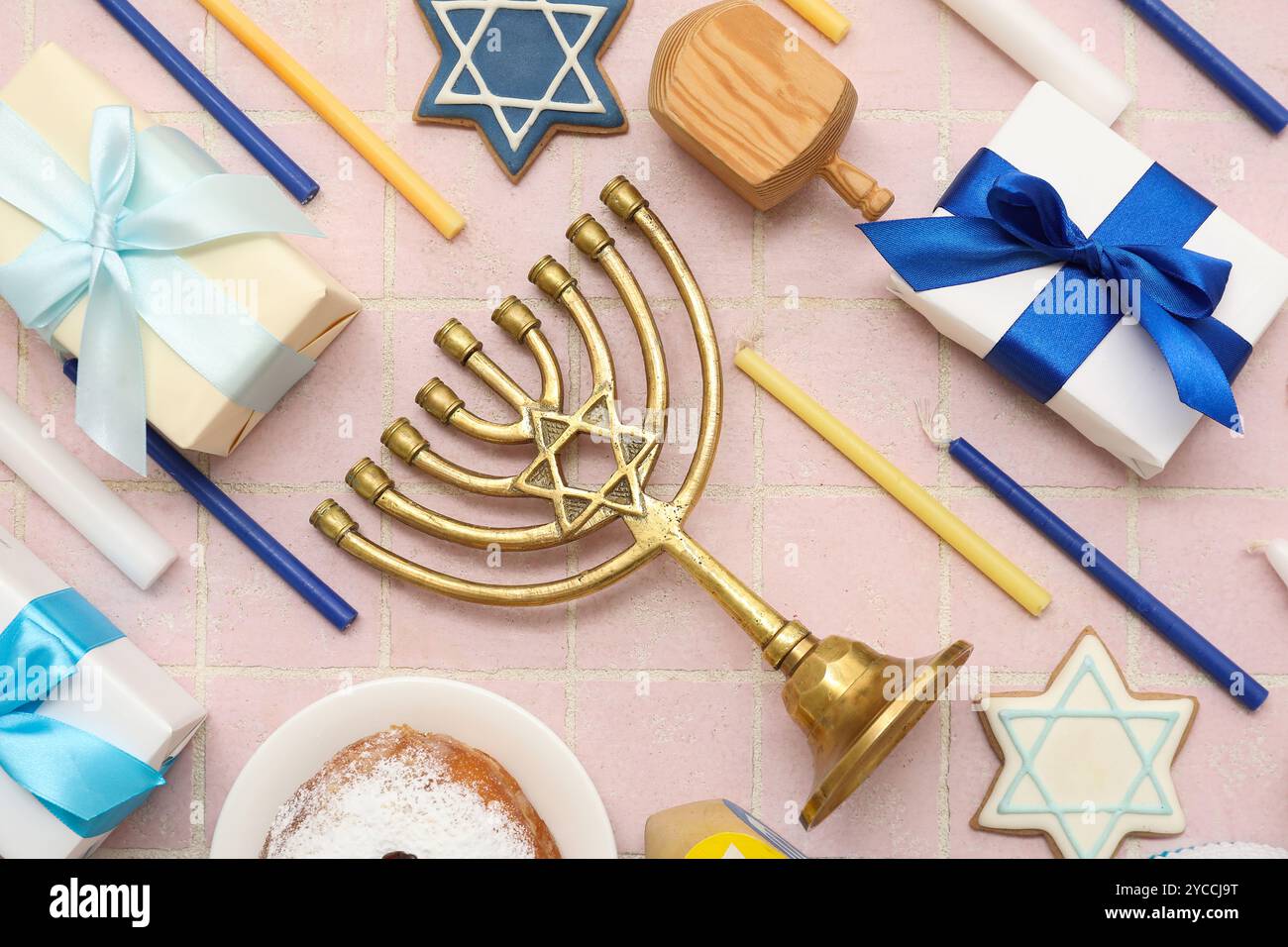 Composition with traditional Hanukkah symbols on pink tiled background ...