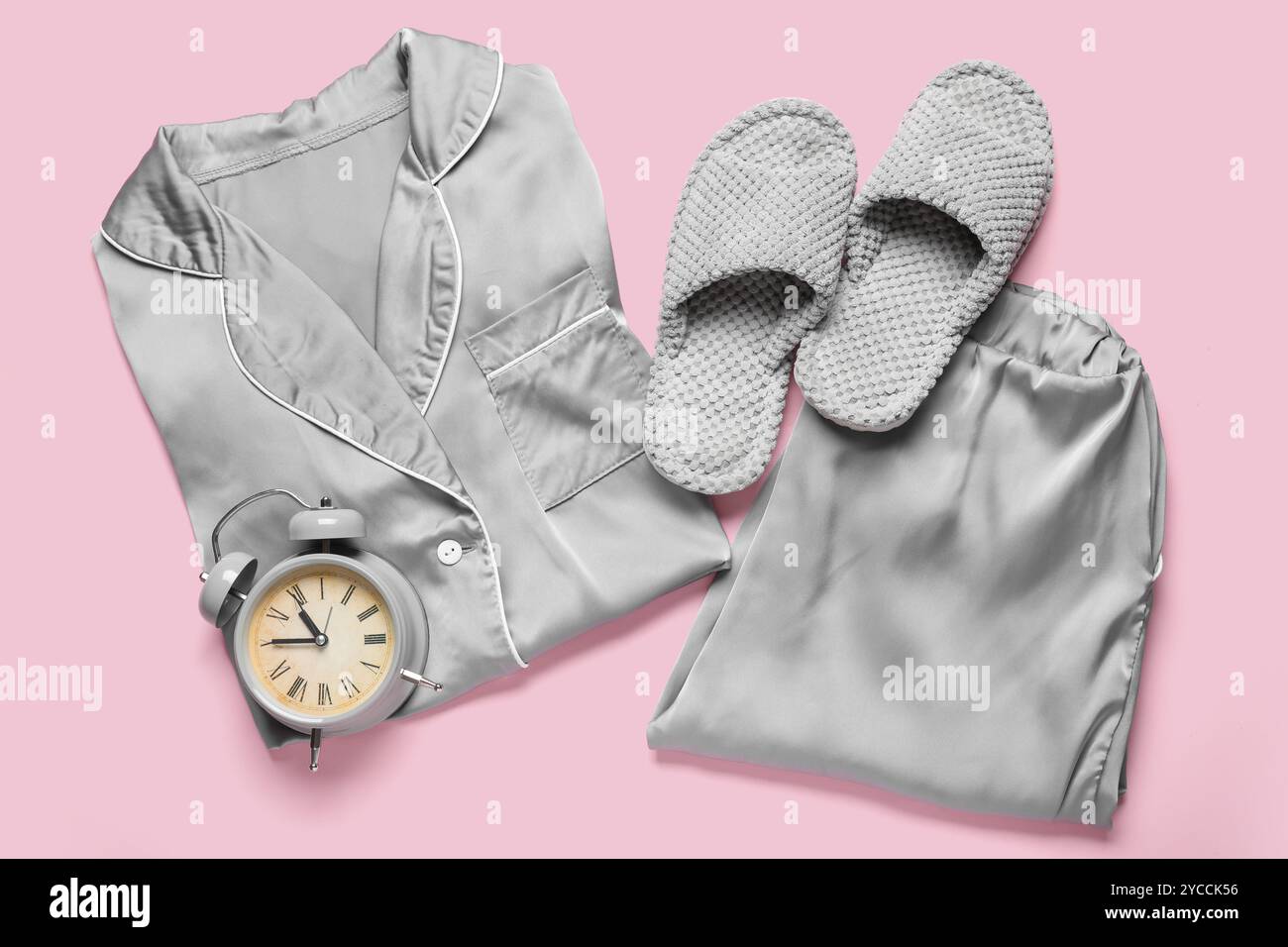 Grey pajamas with slippers and alarm clock on pink background Stock ...