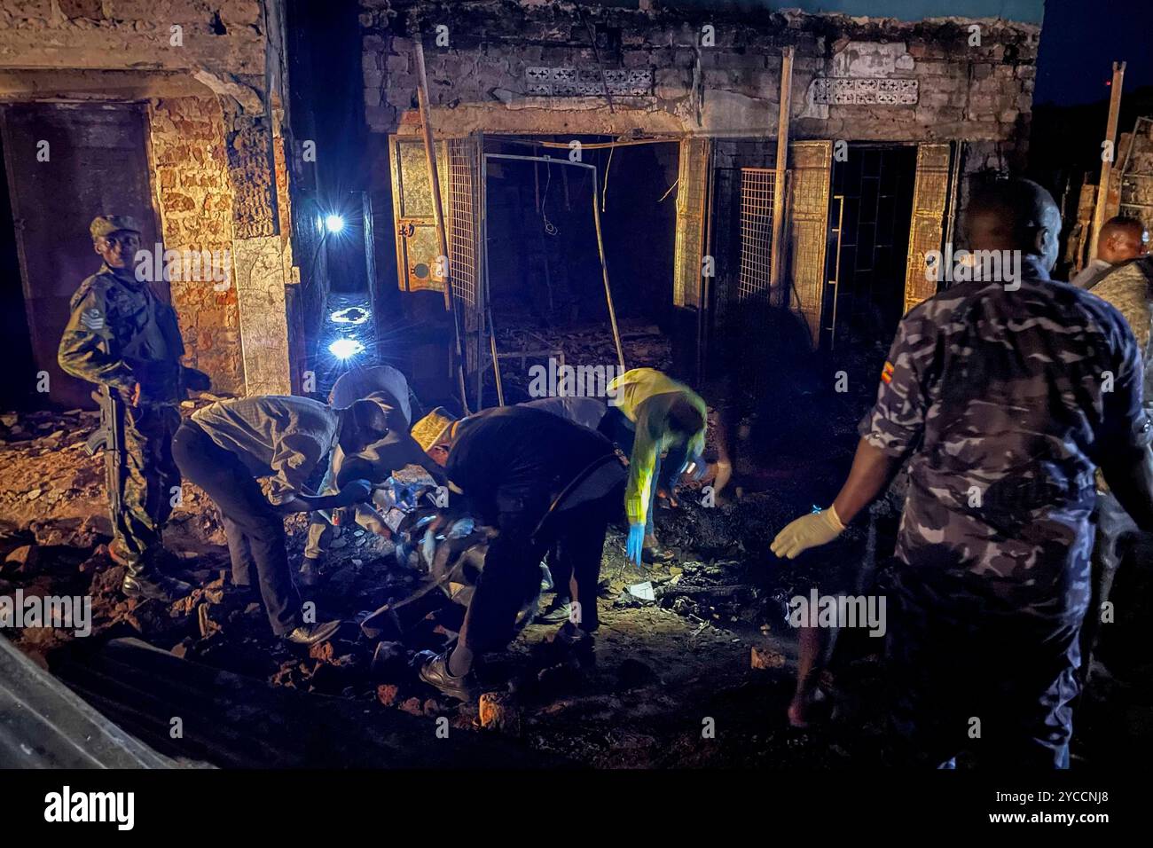 Uganda forensic officials inspect the site where a fuel truck exploded ...