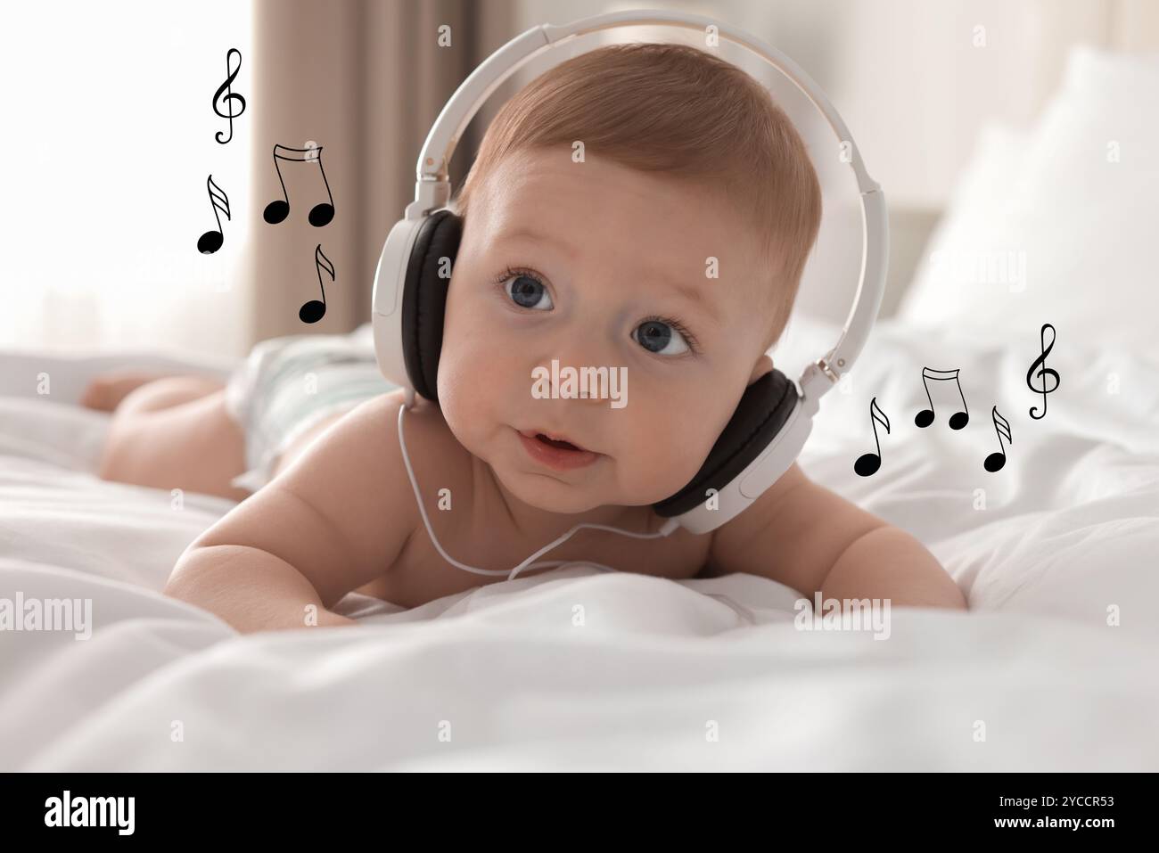 Cute little baby with headphones on bed at home. Music notes flying ...