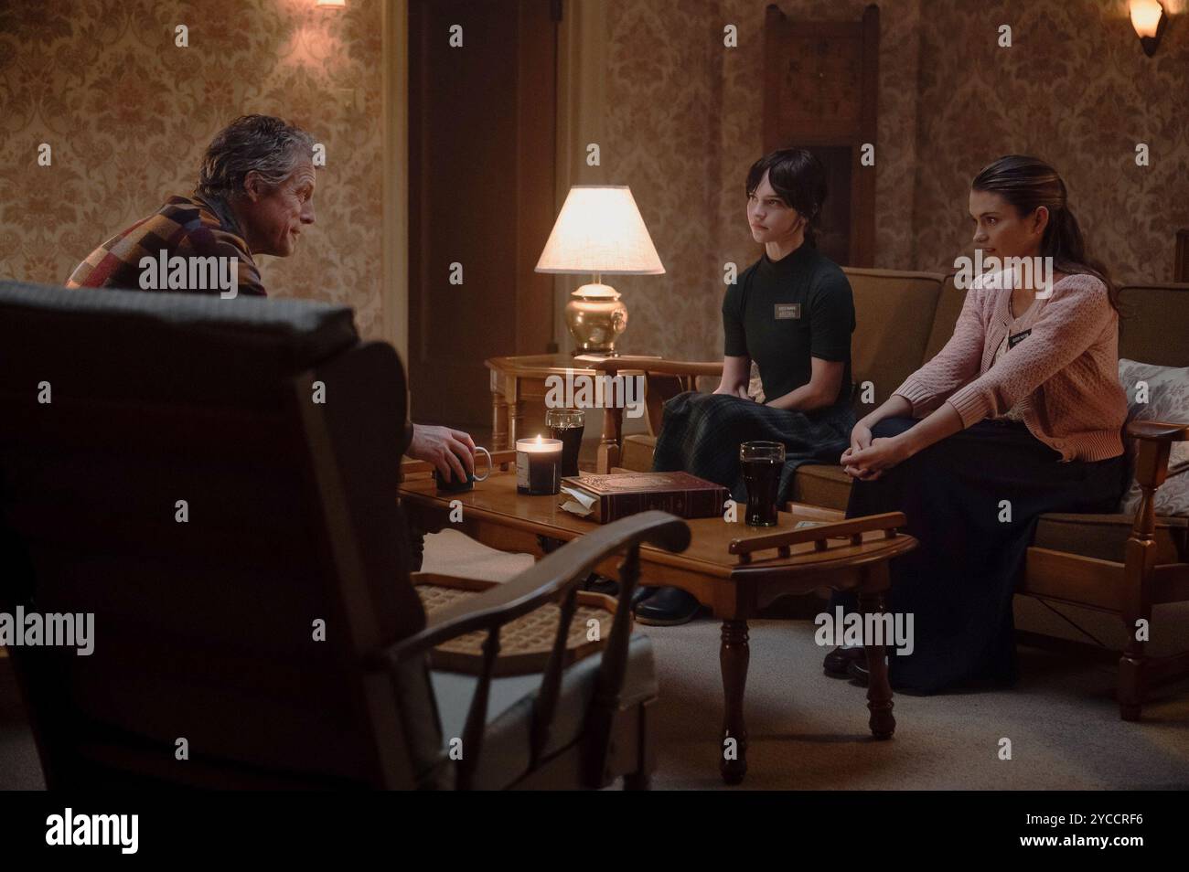 HERETIC, from left: Hugh Grant, Sophie Thatcher, Chloe East, 2024. ph ...