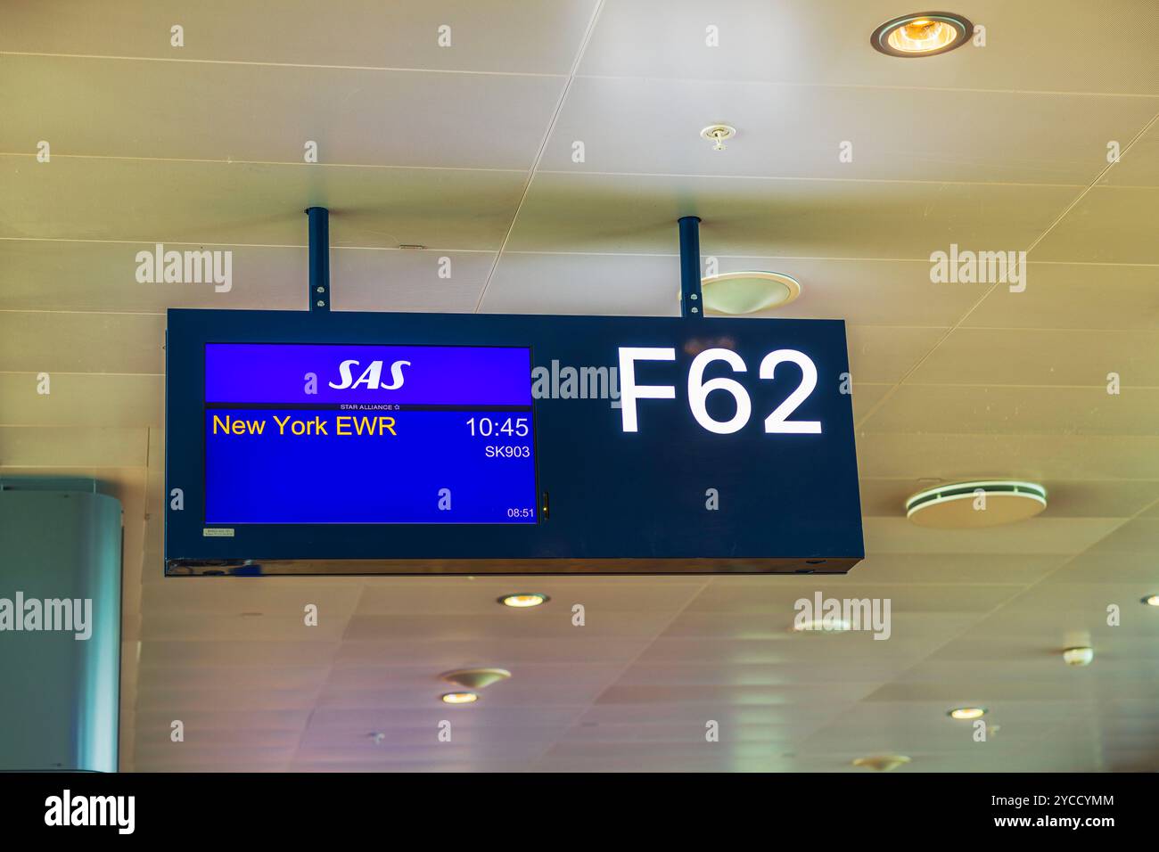 Gate F62 sign for SAS flight to New York EWR shown on airport digital ...
