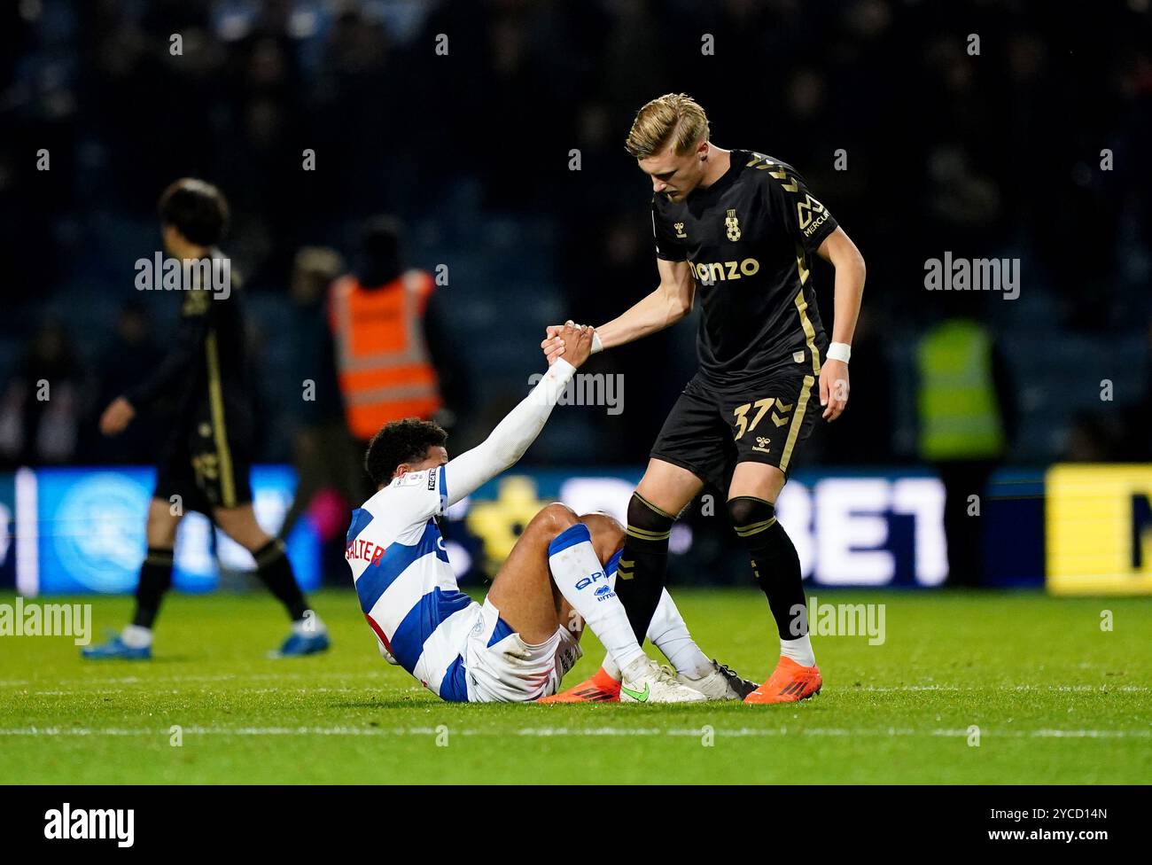 Coventry City's Norman Bassette (right) helps up Queens Park Rangers ...