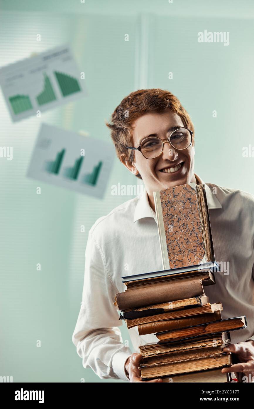 Accountant is holding a stack of old books, smiling broadly, while ...
