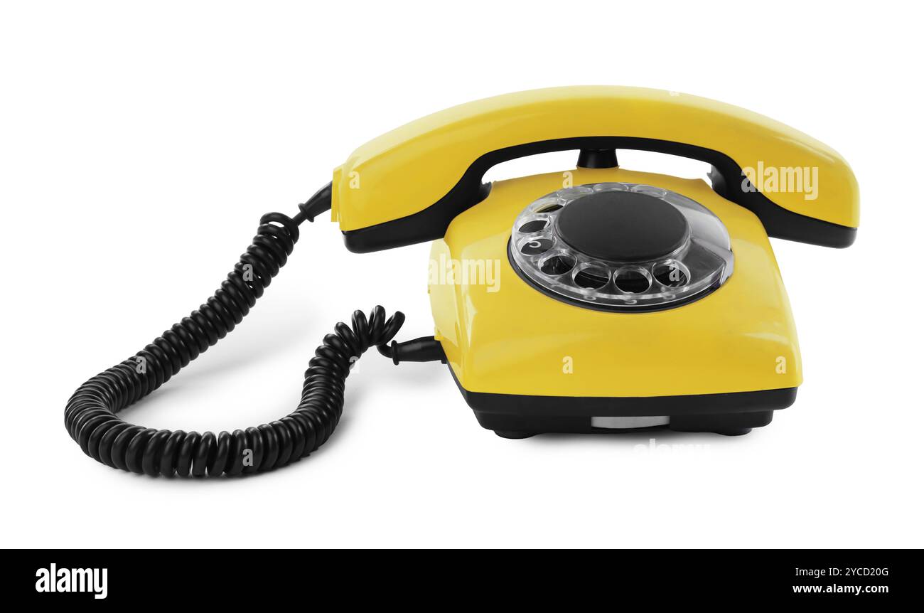 Old yellow telephone with rotary dial isolated on white Stock Photo - Alamy