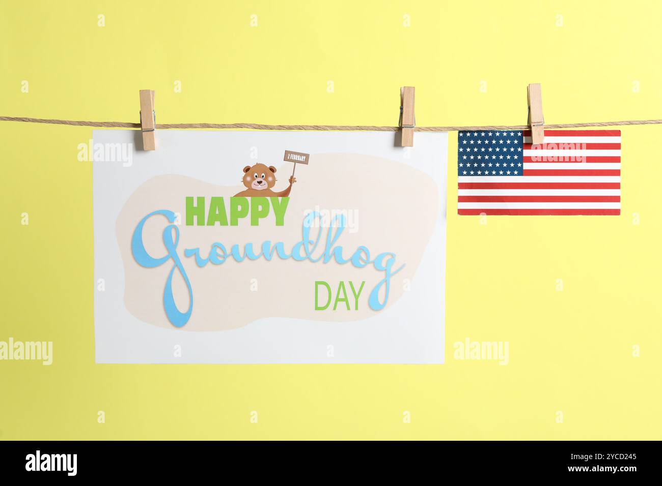 Happy Groundhog Day greeting card and American flag hanging on yellow ...