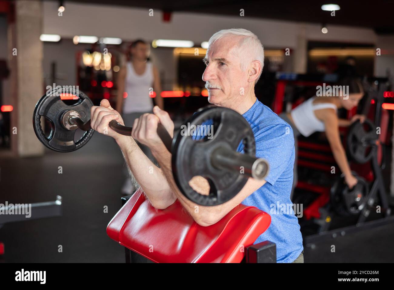 Elderly man training with barbell in gym Stock Photo - Alamy