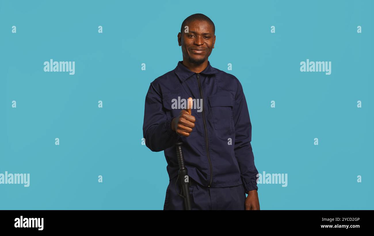 Happy security guard doing thumbs up sign gesturing with finger ...