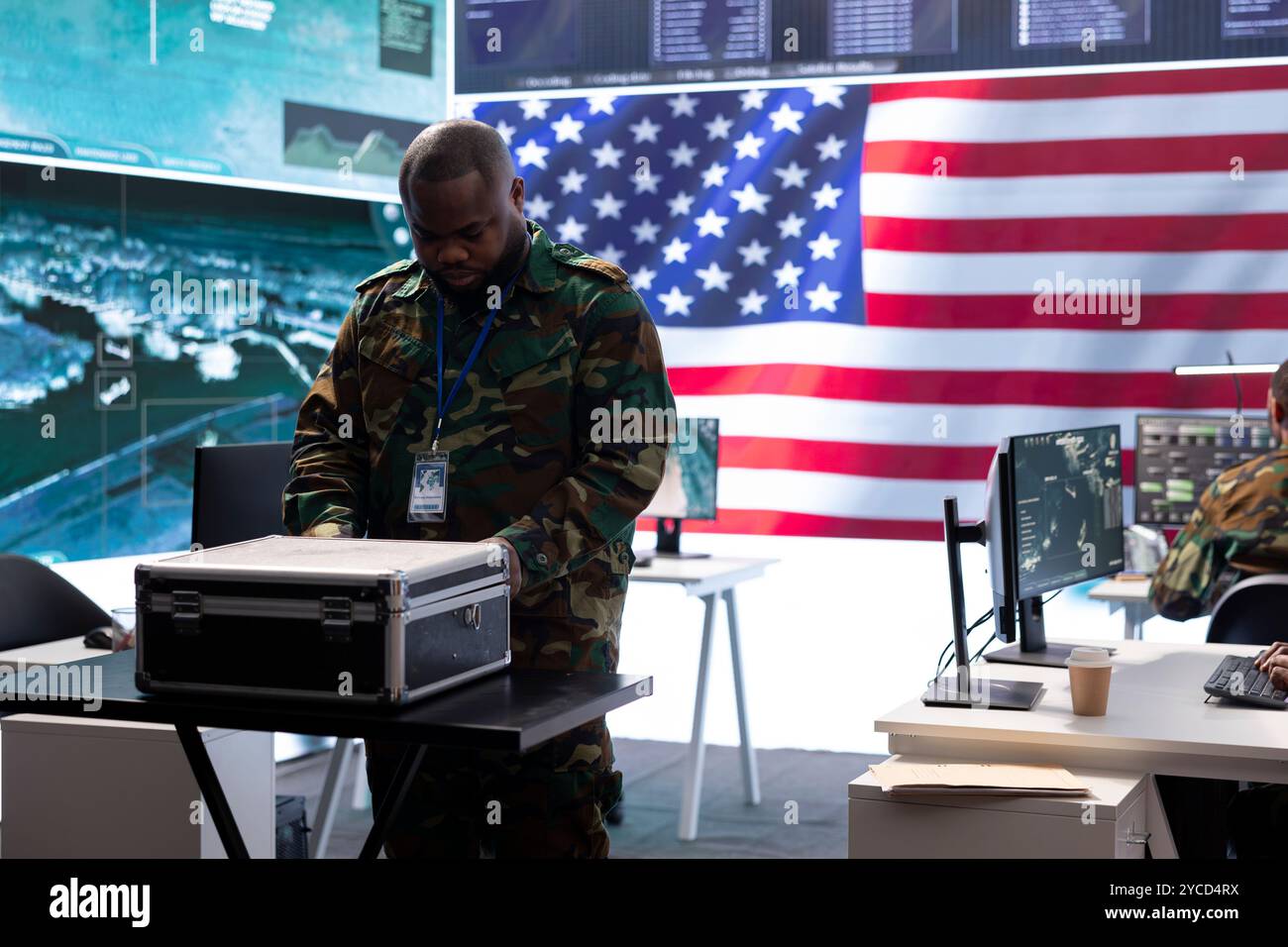 Military personnel team in a high tech command center examining cctv ...