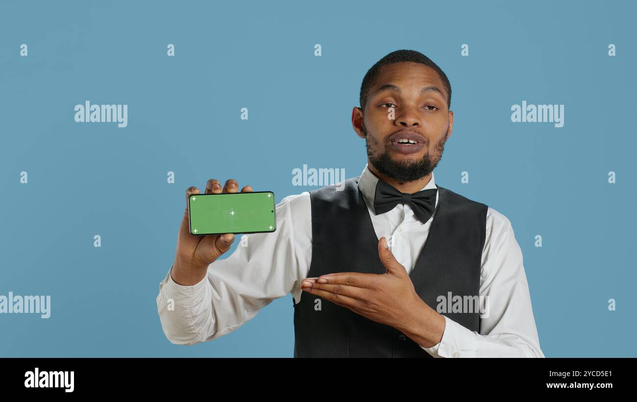 Hotel concierge personnel showing chroma key display on a smartphone ...