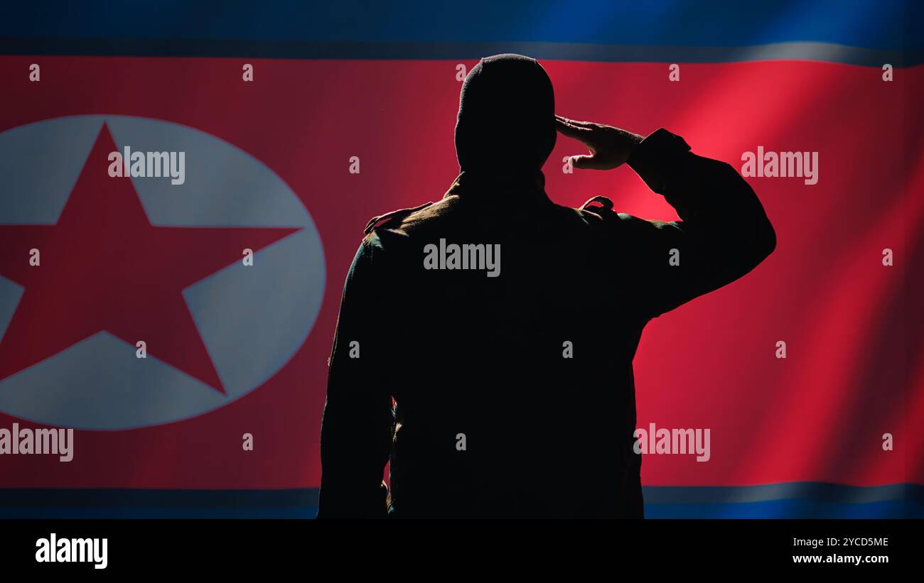 Conscript doing saluting hand gesture towards North Korea flag in ...