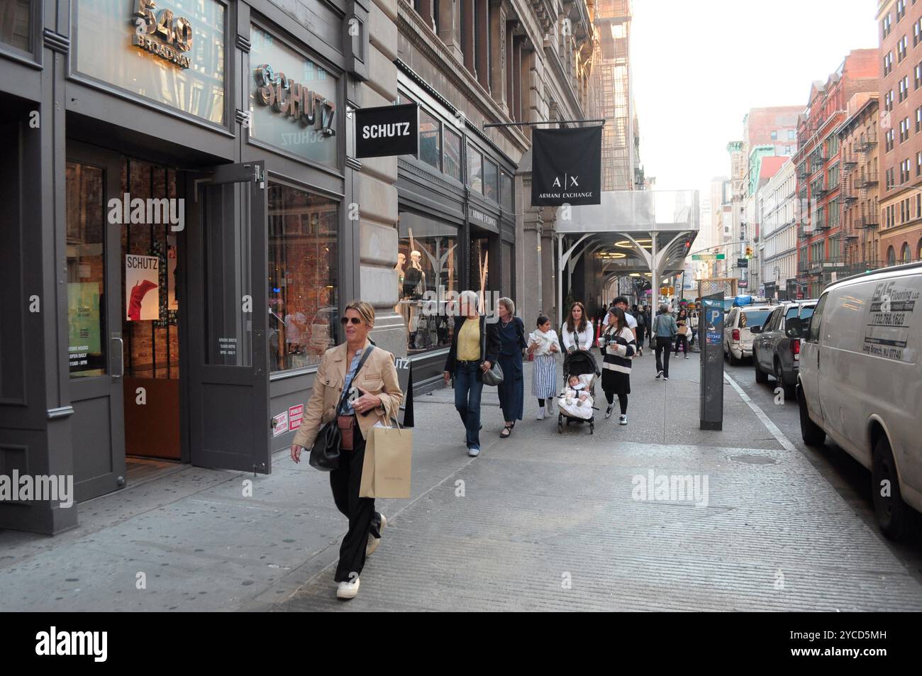 People walk down the street in the SoHo neighborhood in Manhattan, New ...