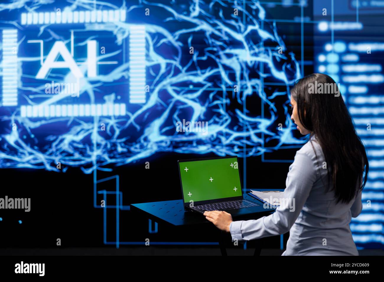 IT expert using green screen laptop and AI technology for business data analysis in high tech ...