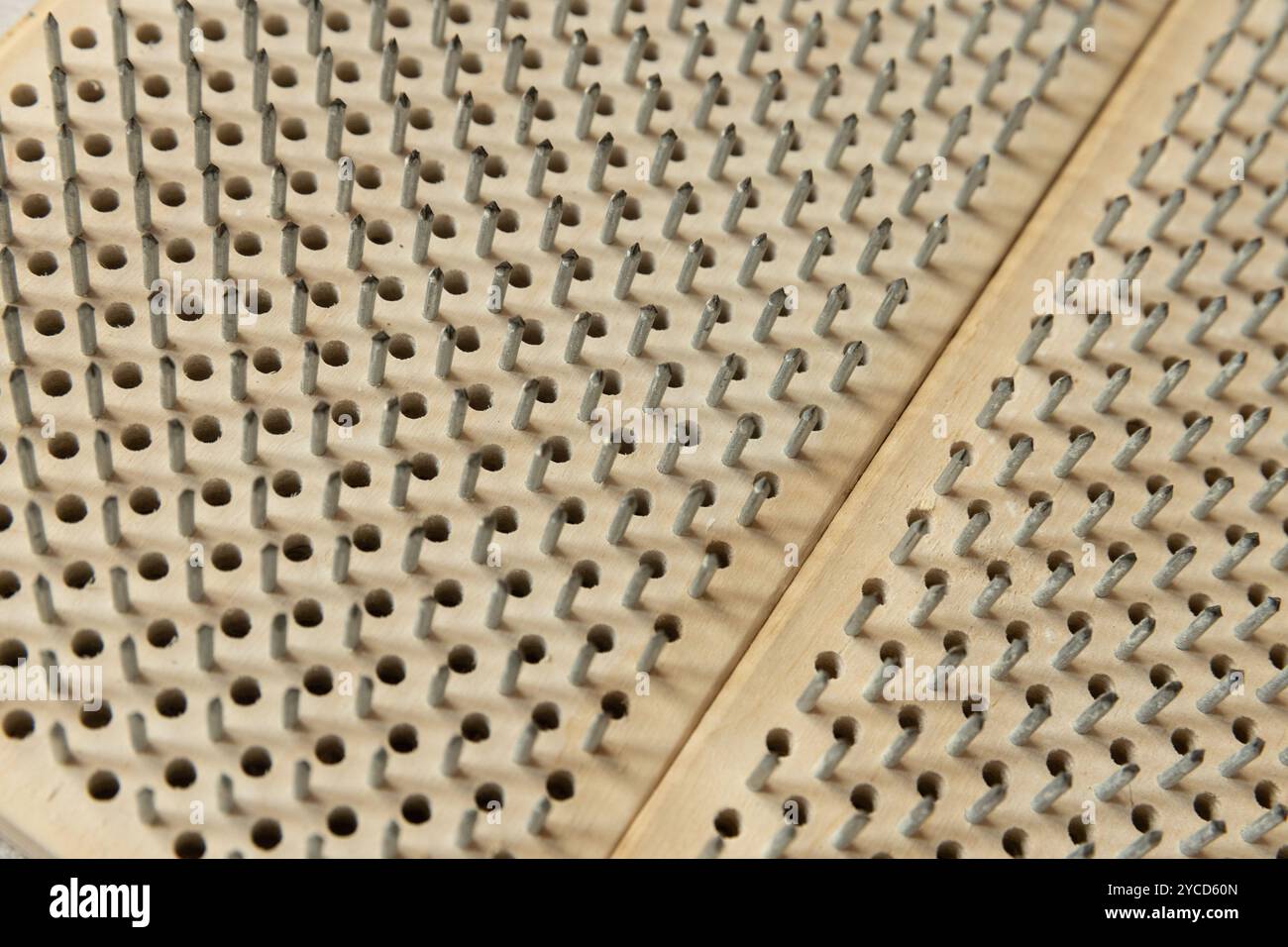 Close-up of metal spikes on a sadhu acupressure board, showing the ...