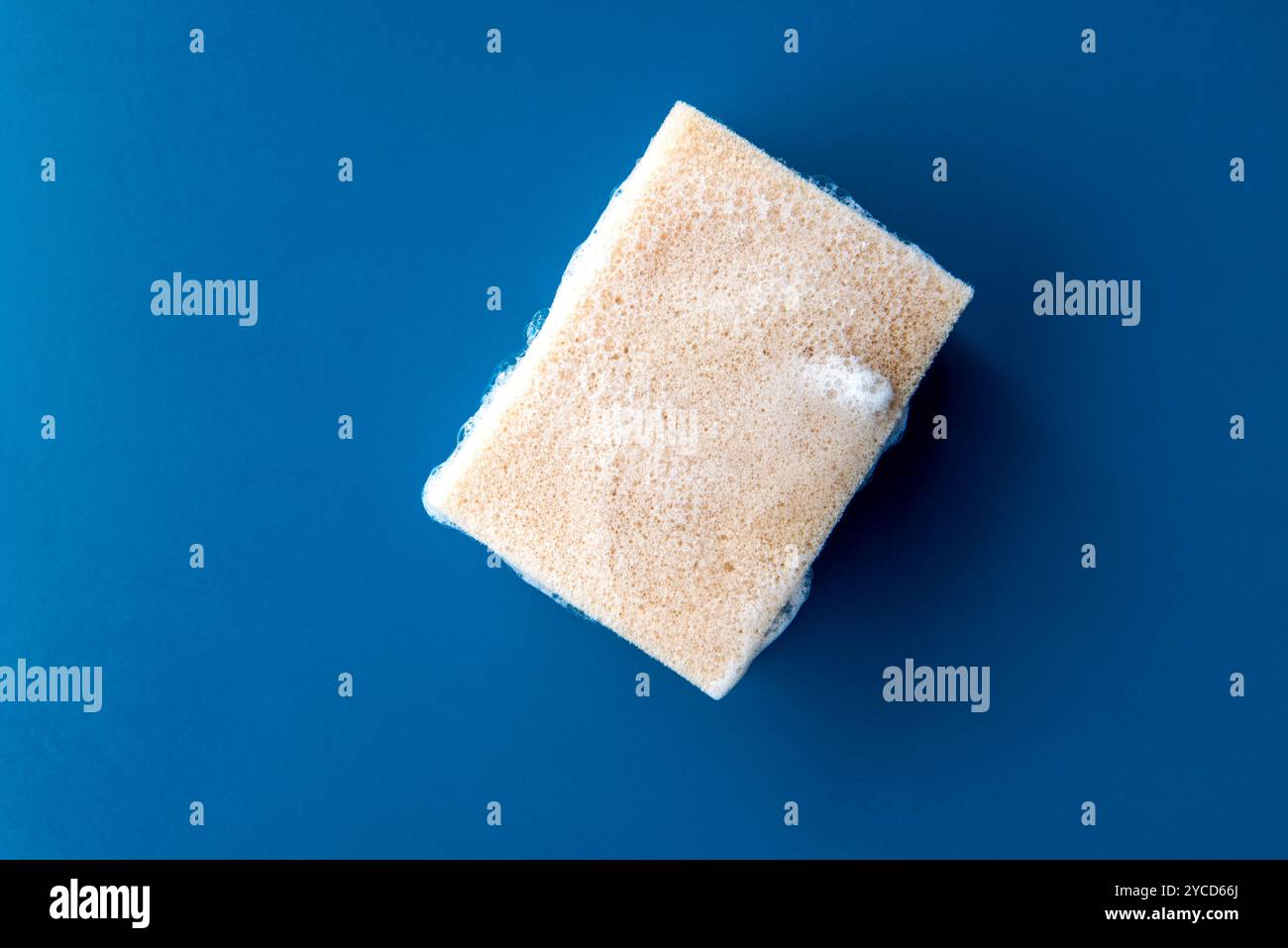 foam sponge for washing dishes on blue ceramic table, copy space Stock ...