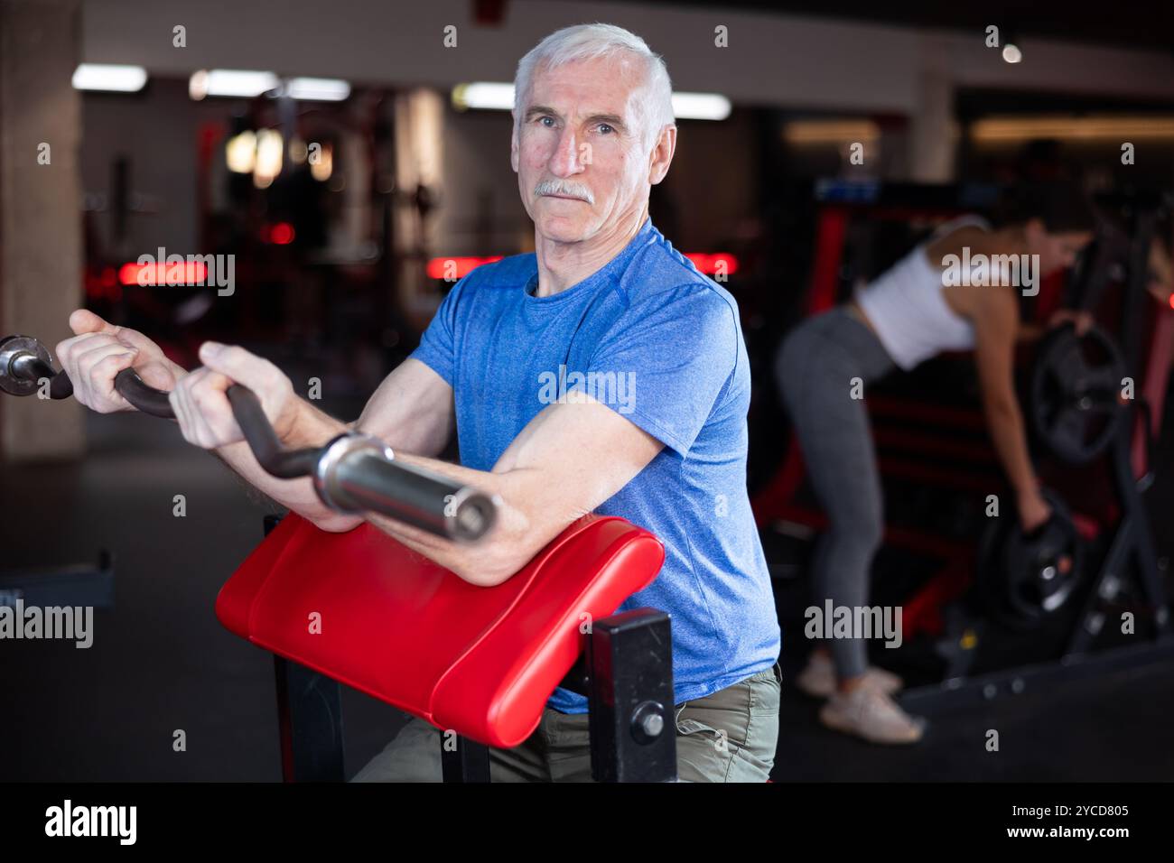 Elderly man training with barbell in gym Stock Photo - Alamy