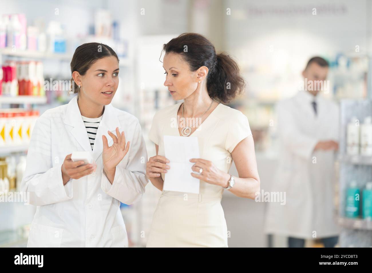 Female pharmacist helping woman with prescription choosing medical ...