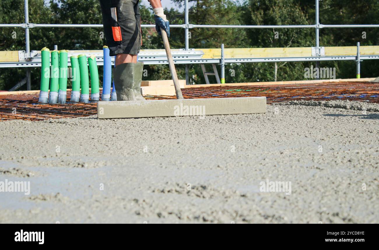 Workers filling the second floor ground with concrete, core and shell ...