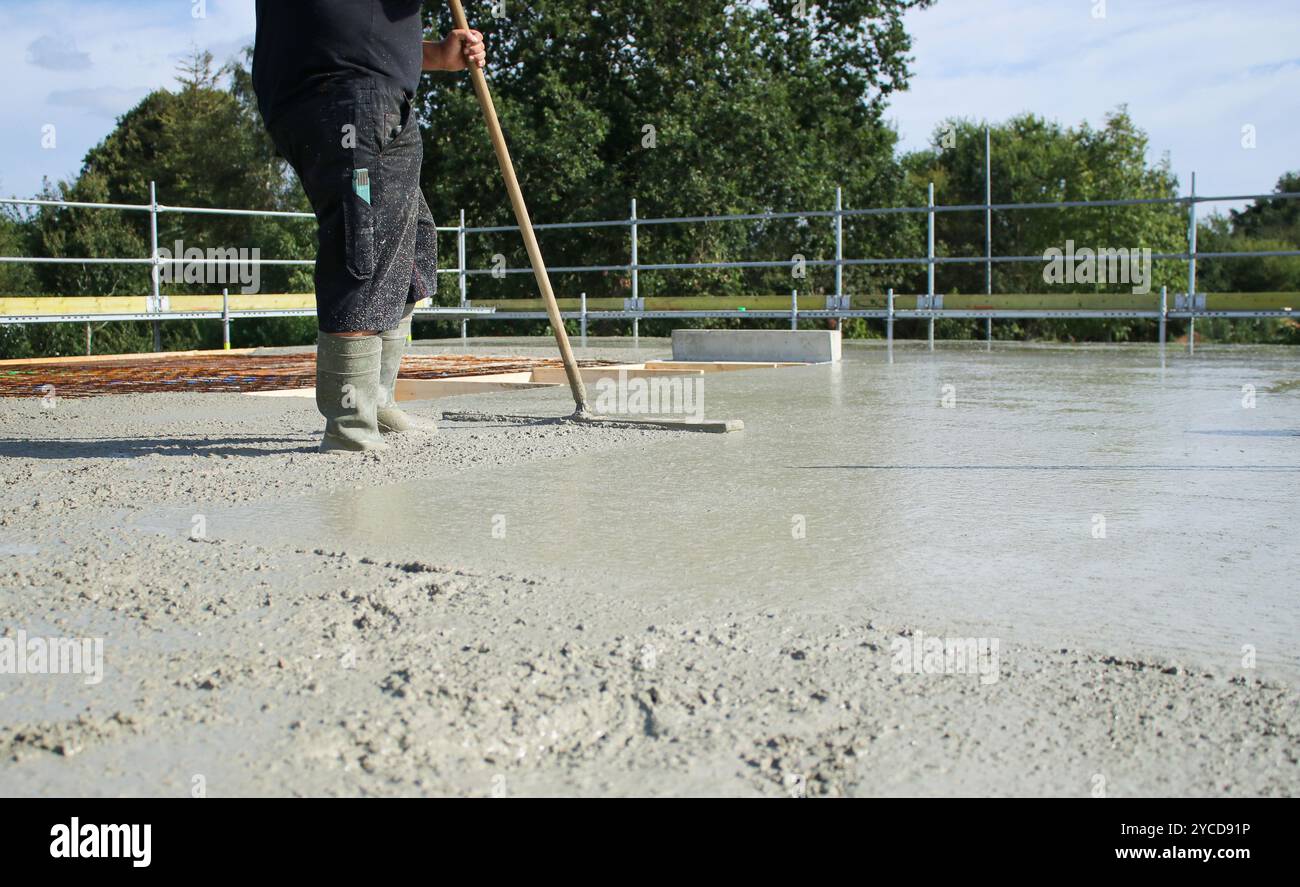 Workers filling the second floor ground with concrete, core and shell ...