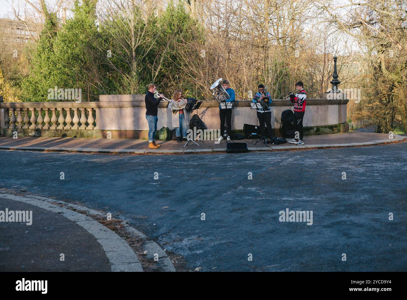 Young brass quintet busking on a busy bridge in Kelvingrove Park ...