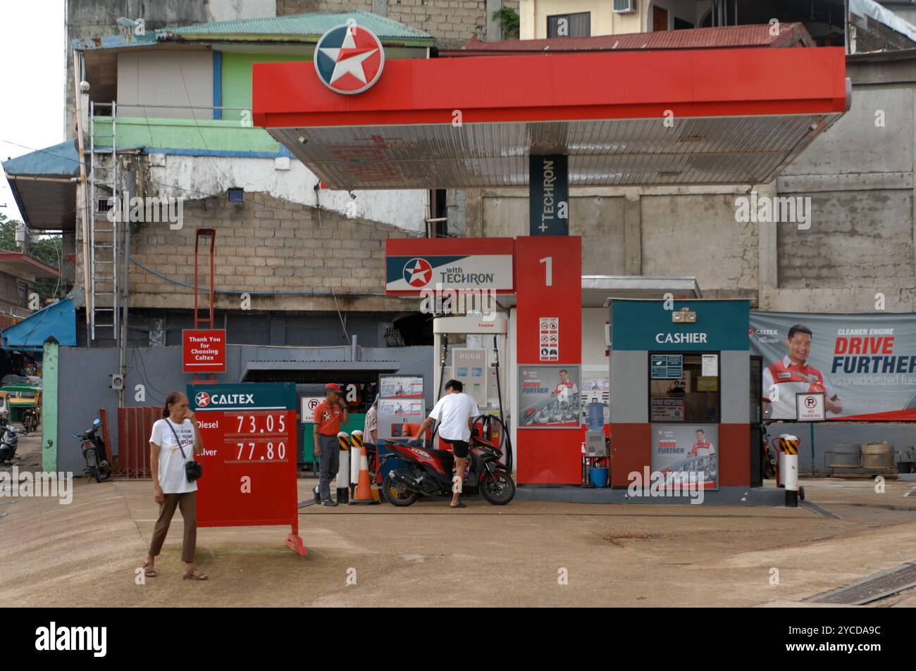 Tuk Tuks and motorcycles filling up at Caltex petrol station, Coron ...