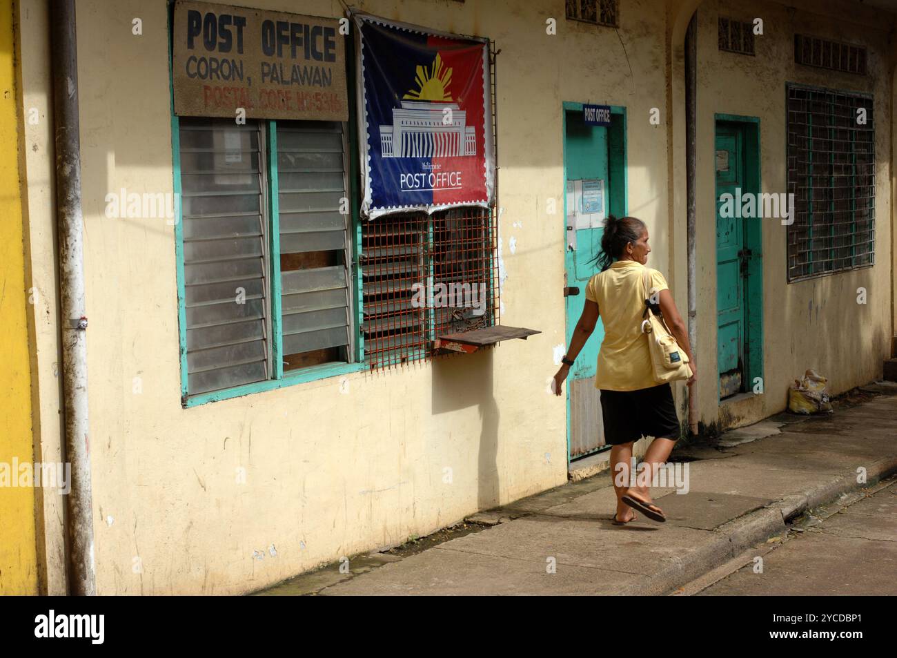 Woman walking past Post Office, Coron, Palawan, Philippines Stock Photo ...