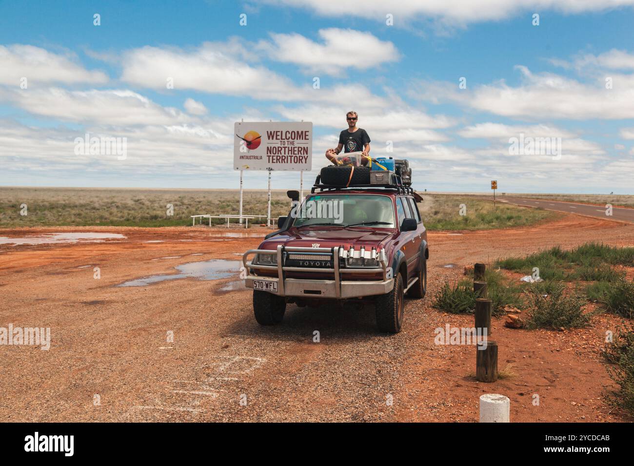 A traveler enjoys the rugged beauty of the Australian Outback, sitting ...