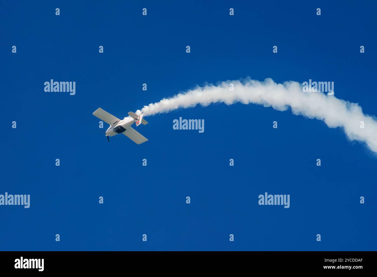Stunt aerobatic plane performing stunts in air Stock Photo - Alamy